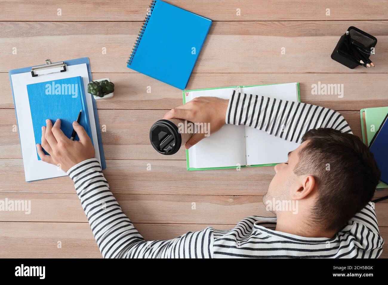 Tired student sleeping at table, top view Stock Photo - Alamy