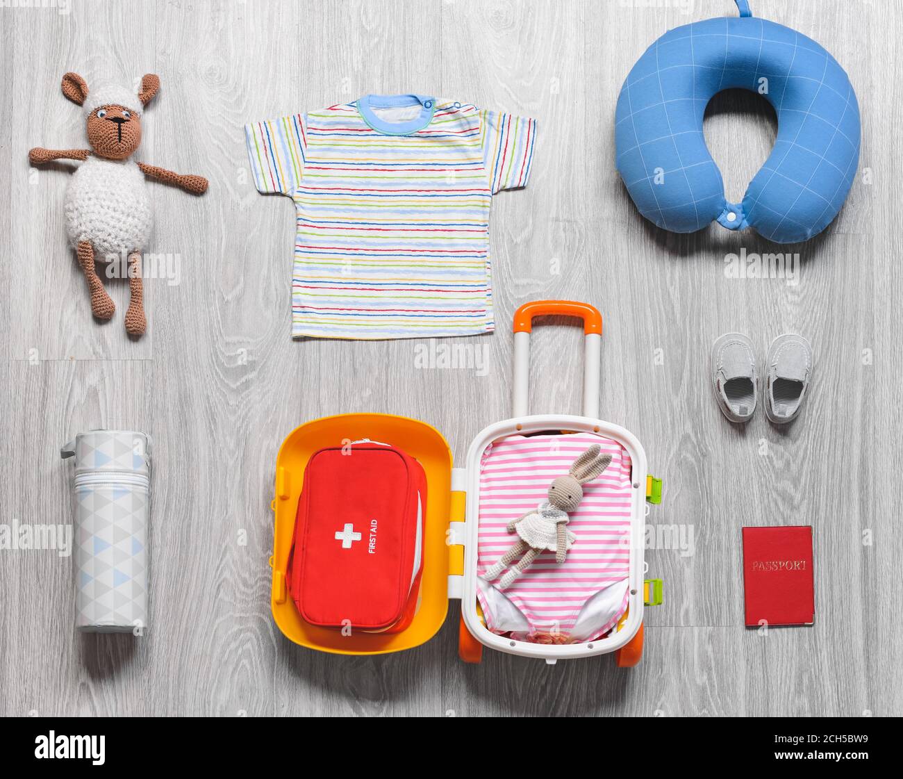 Travel accessories for children on wooden background Stock Photo - Alamy
