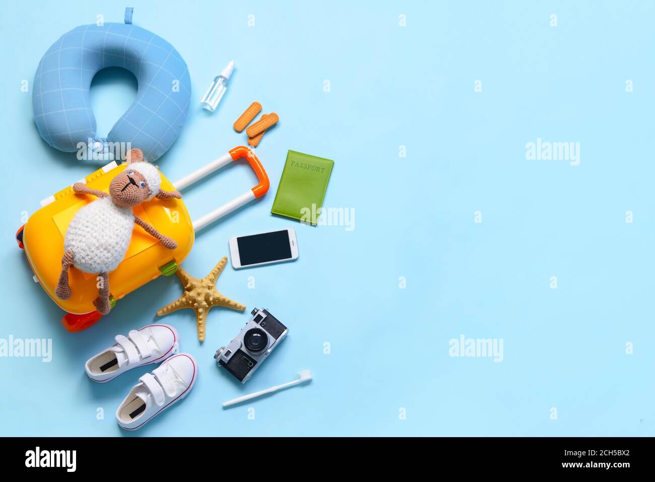 Travel accessories for children on color background Stock Photo - Alamy