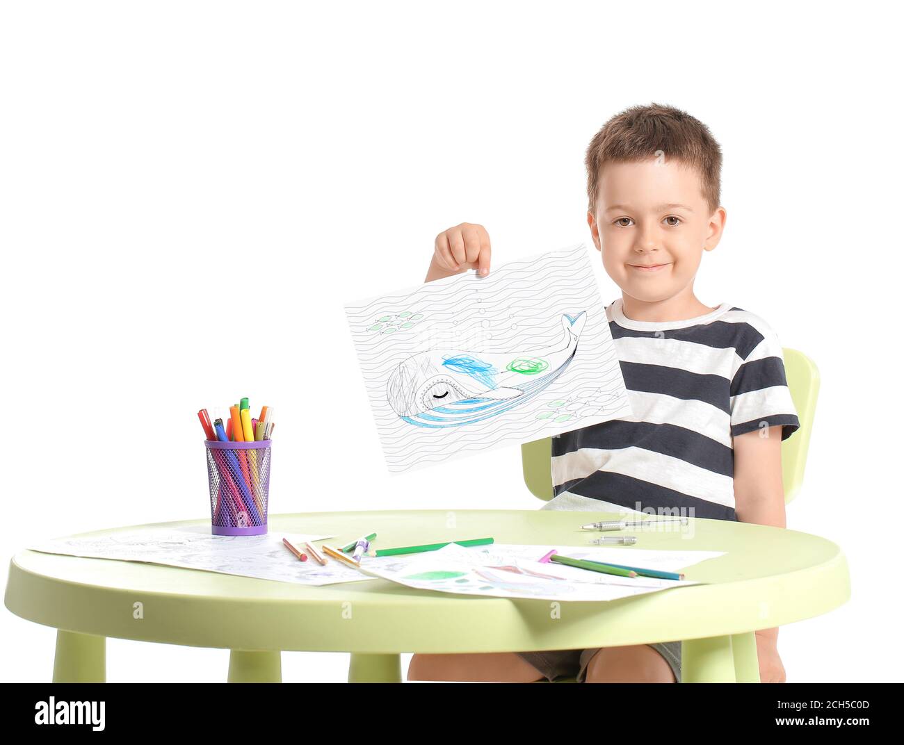 Cute little boy coloring pictures on white background Stock Photo - Alamy