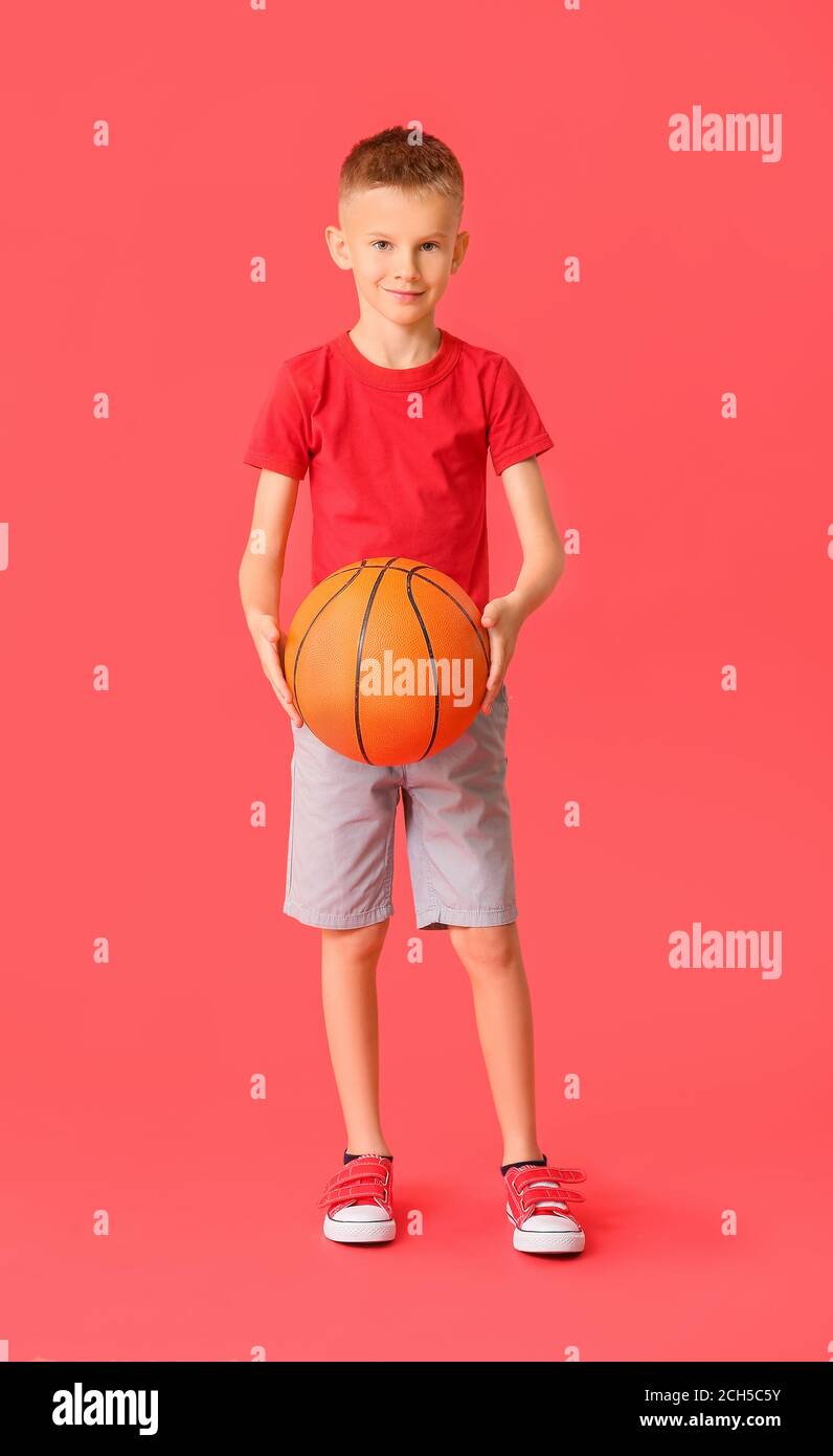 Cute little basketball player on color background Stock Photo - Alamy