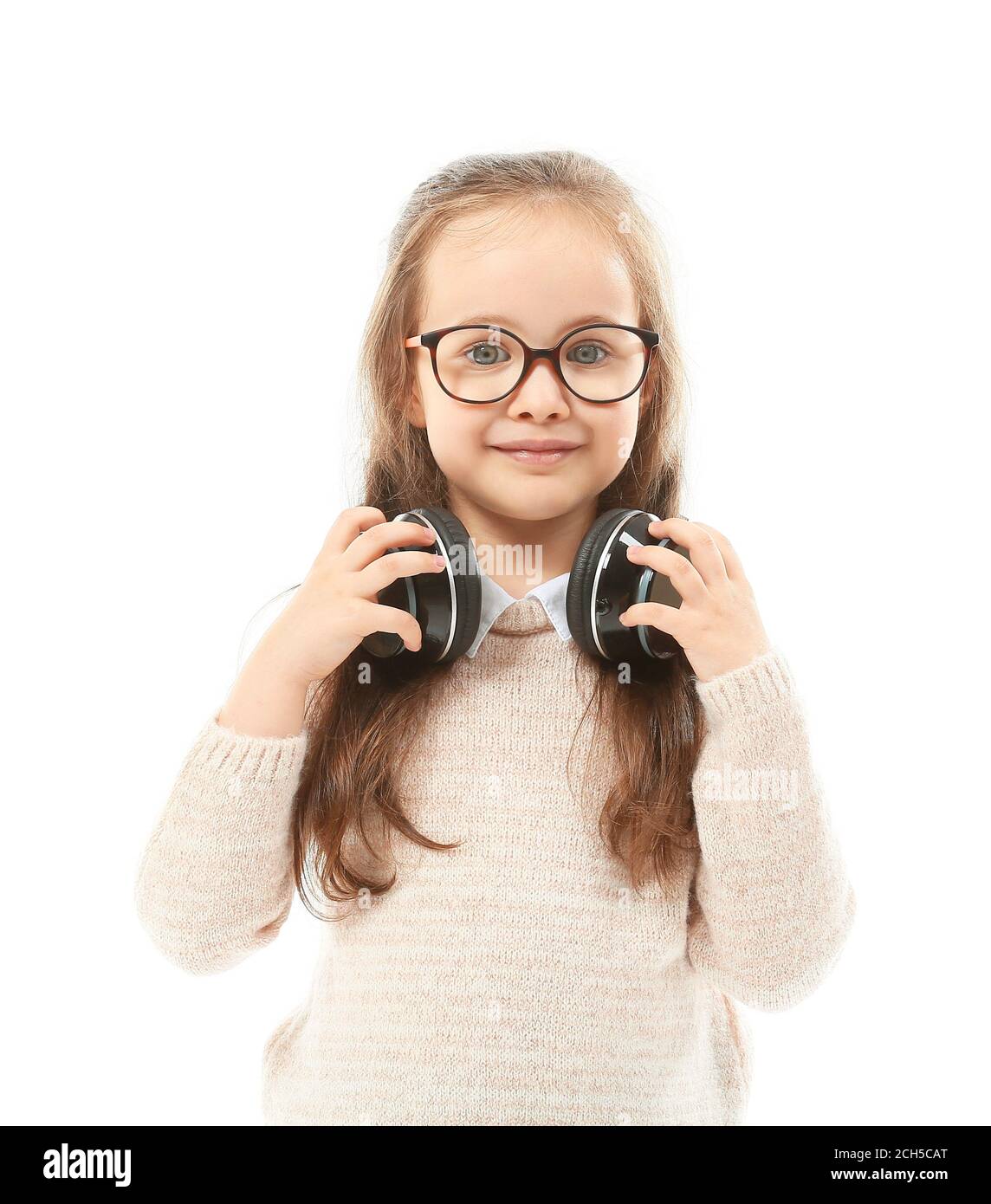 Cute little girl with headphones on white background Stock Photo - Alamy