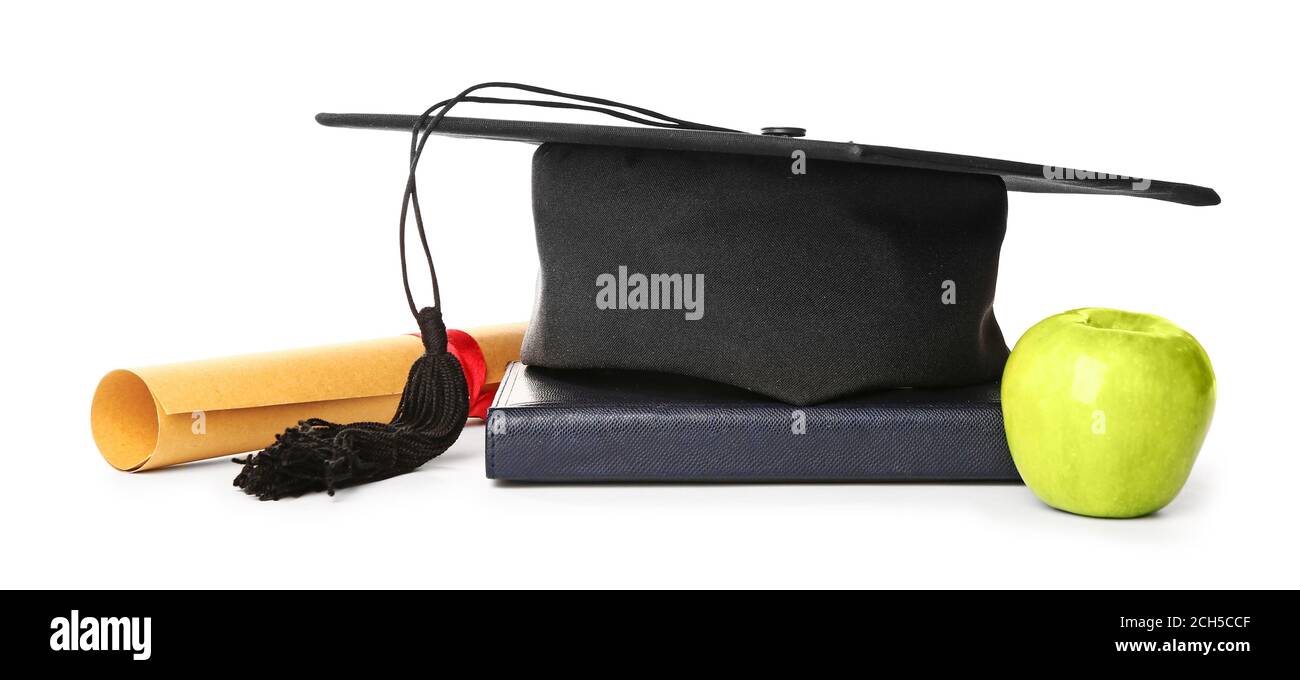 Graduation hat, diploma, apple and book on white background Stock Photo ...
