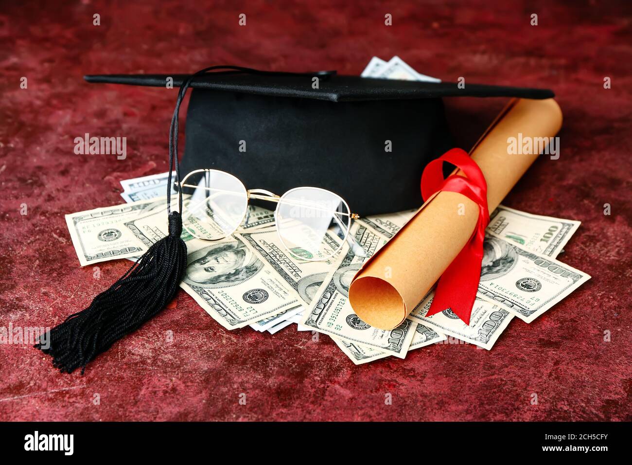 Graduation hat, diploma and money on grunge background. Tuition fees ...