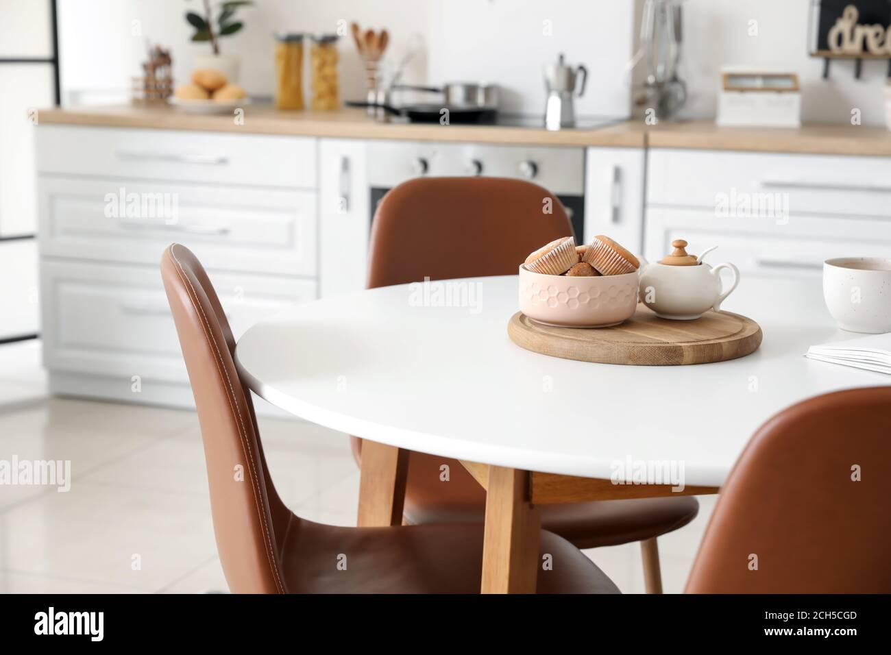Dining table in interior of modern kitchen Stock Photo - Alamy