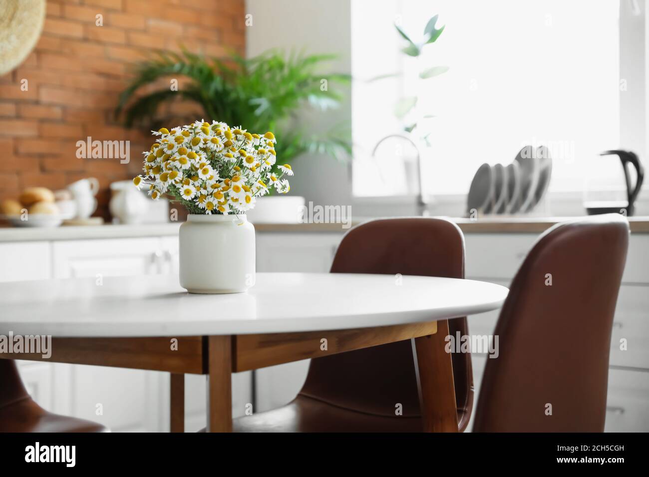 Dining table in interior of modern kitchen Stock Photo - Alamy