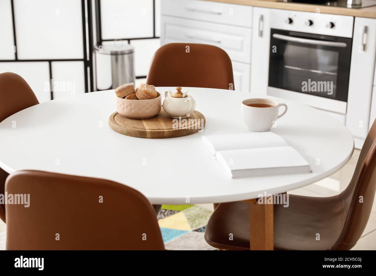 Dining table in interior of modern kitchen Stock Photo - Alamy