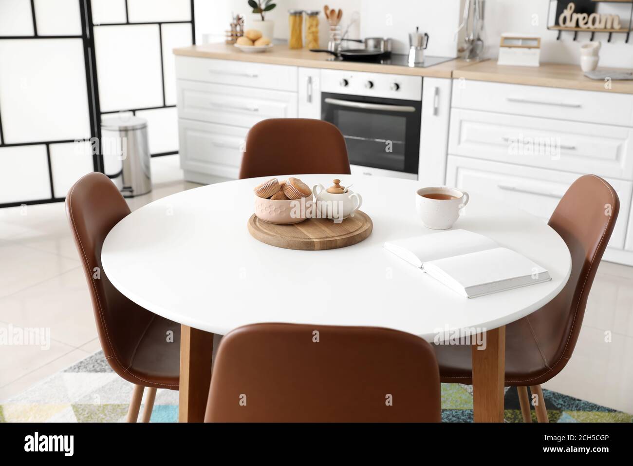 Dining table in interior of modern kitchen Stock Photo - Alamy