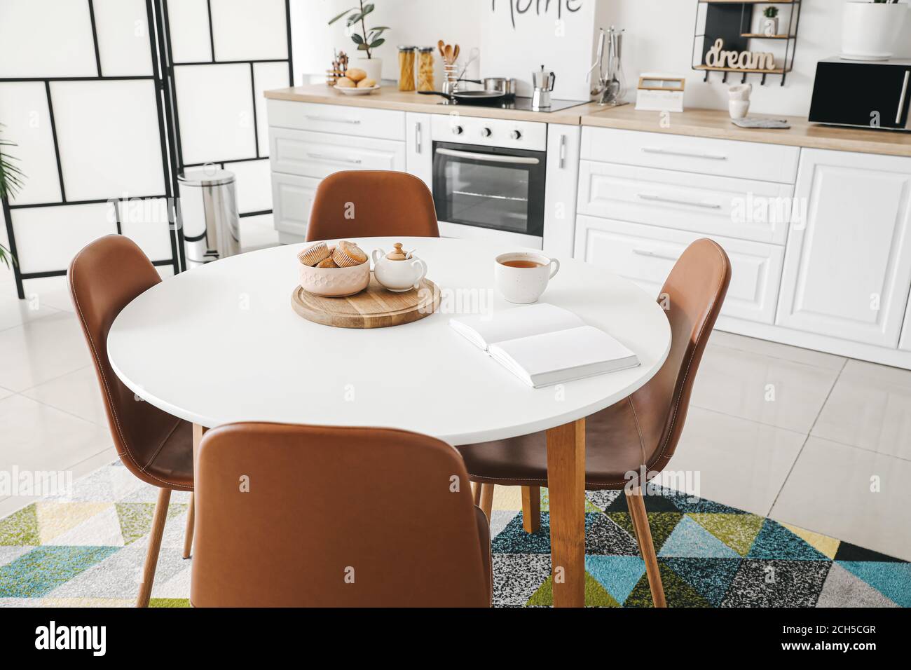 Dining table in interior of modern kitchen Stock Photo - Alamy