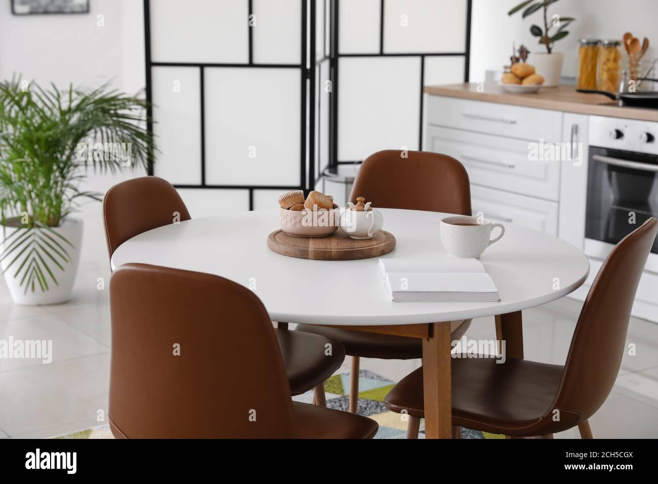 Dining table in interior of modern kitchen Stock Photo - Alamy