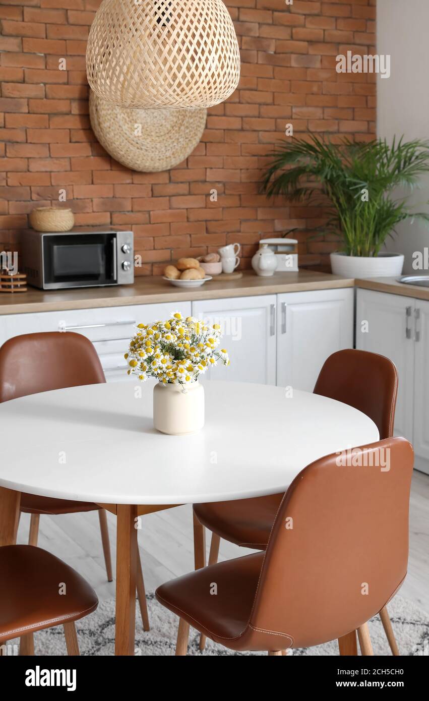 Dining table in interior of modern kitchen Stock Photo - Alamy