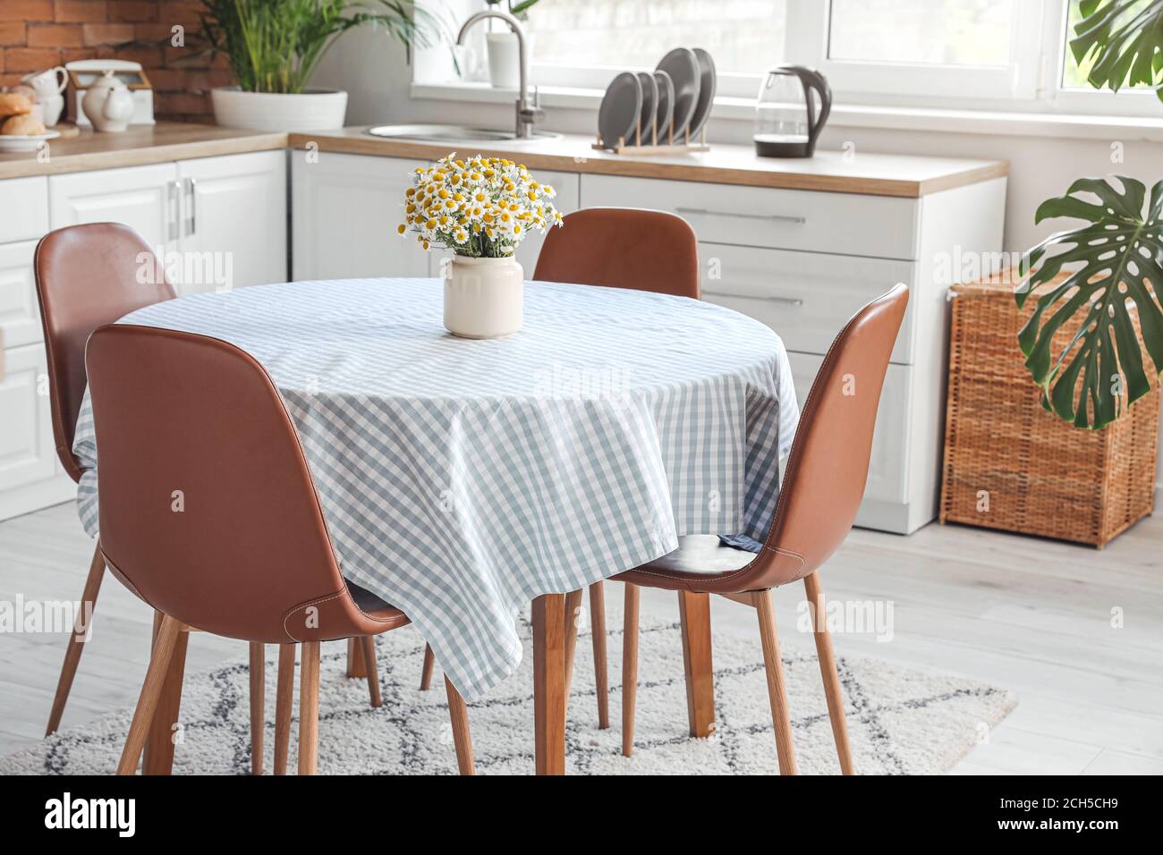 Dining table in interior of modern kitchen Stock Photo - Alamy
