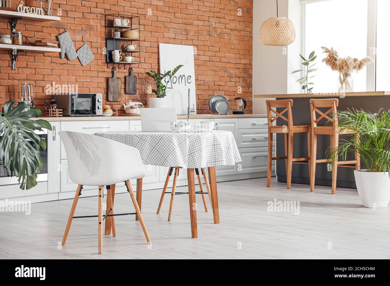 Interior of stylish modern kitchen with dining table Stock Photo - Alamy