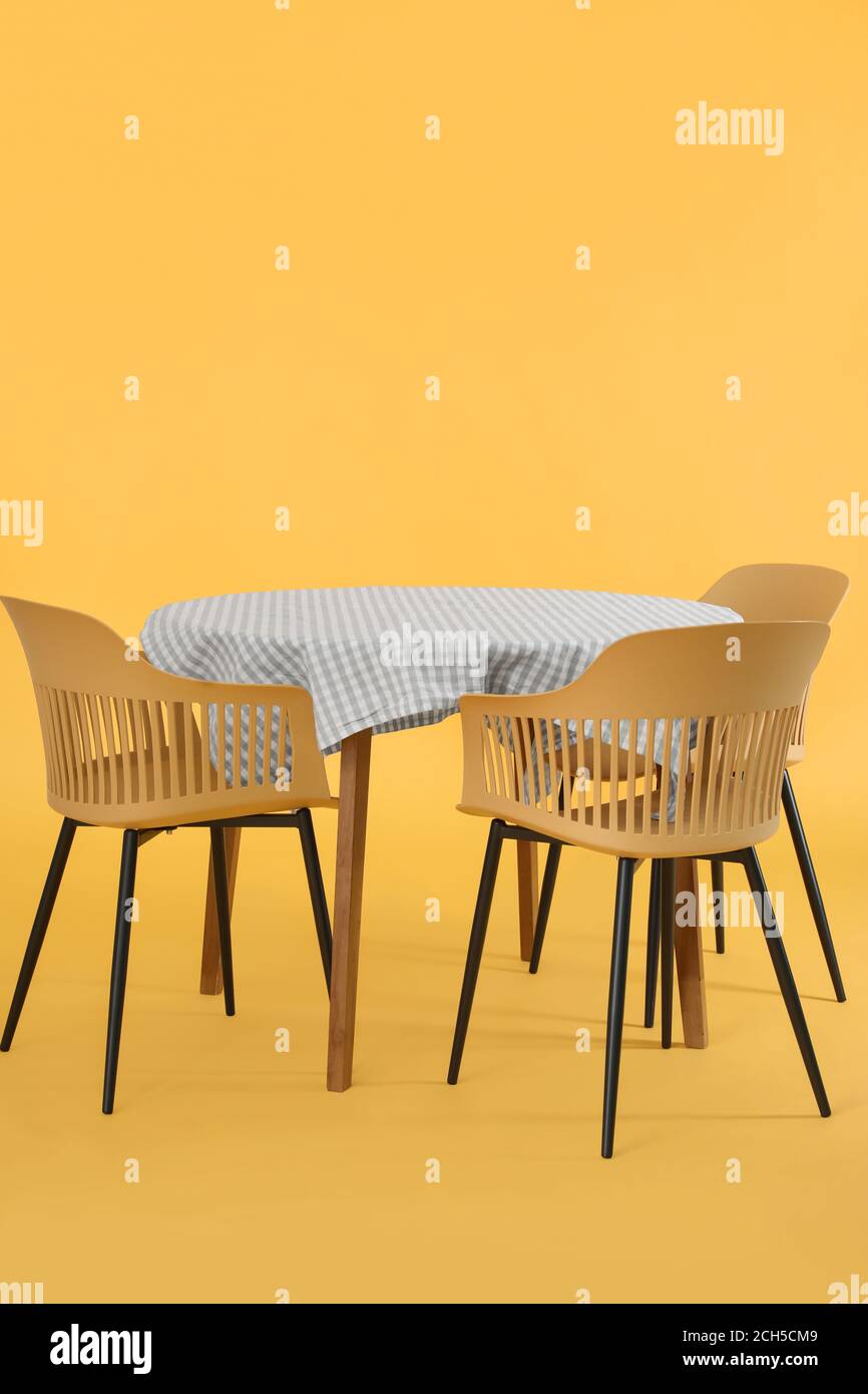 Dining table with chairs on color background Stock Photo - Alamy
