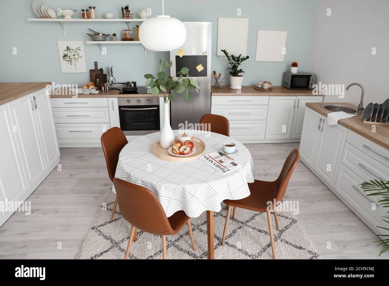Interior of stylish modern kitchen with dining table Stock Photo - Alamy