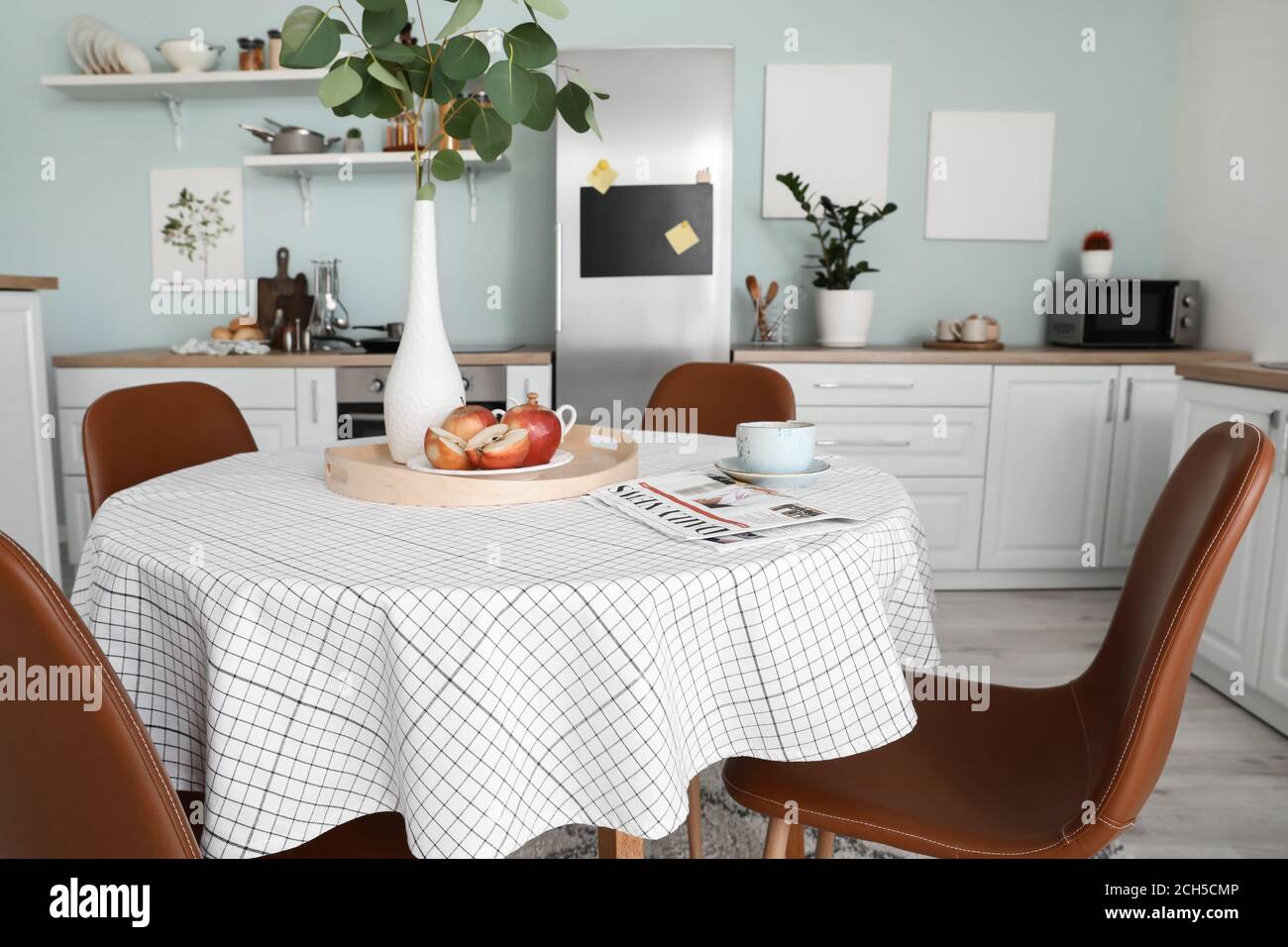 Dining table in interior of modern kitchen Stock Photo - Alamy