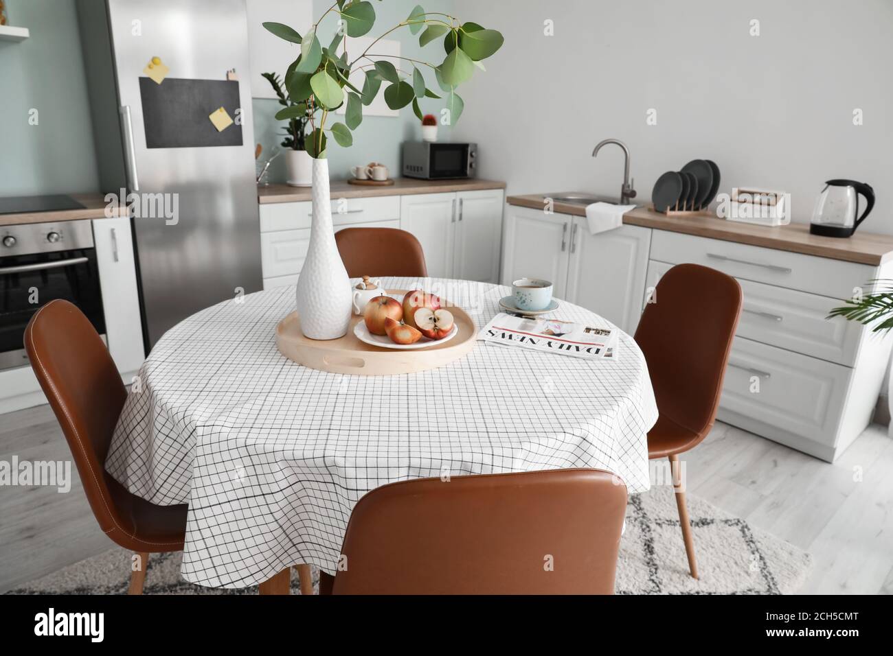 Dining table in interior of modern kitchen Stock Photo - Alamy