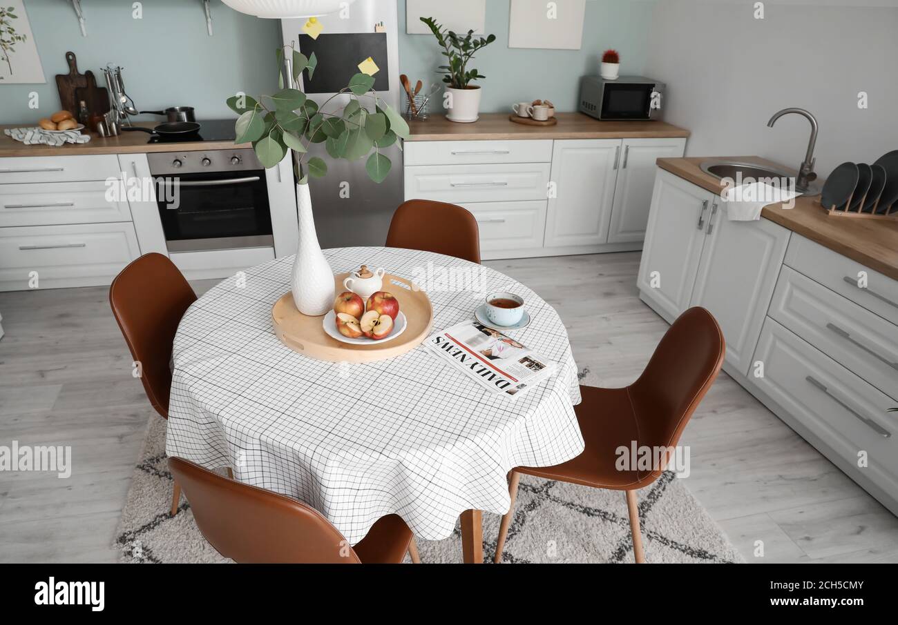 Interior of stylish modern kitchen with dining table Stock Photo - Alamy