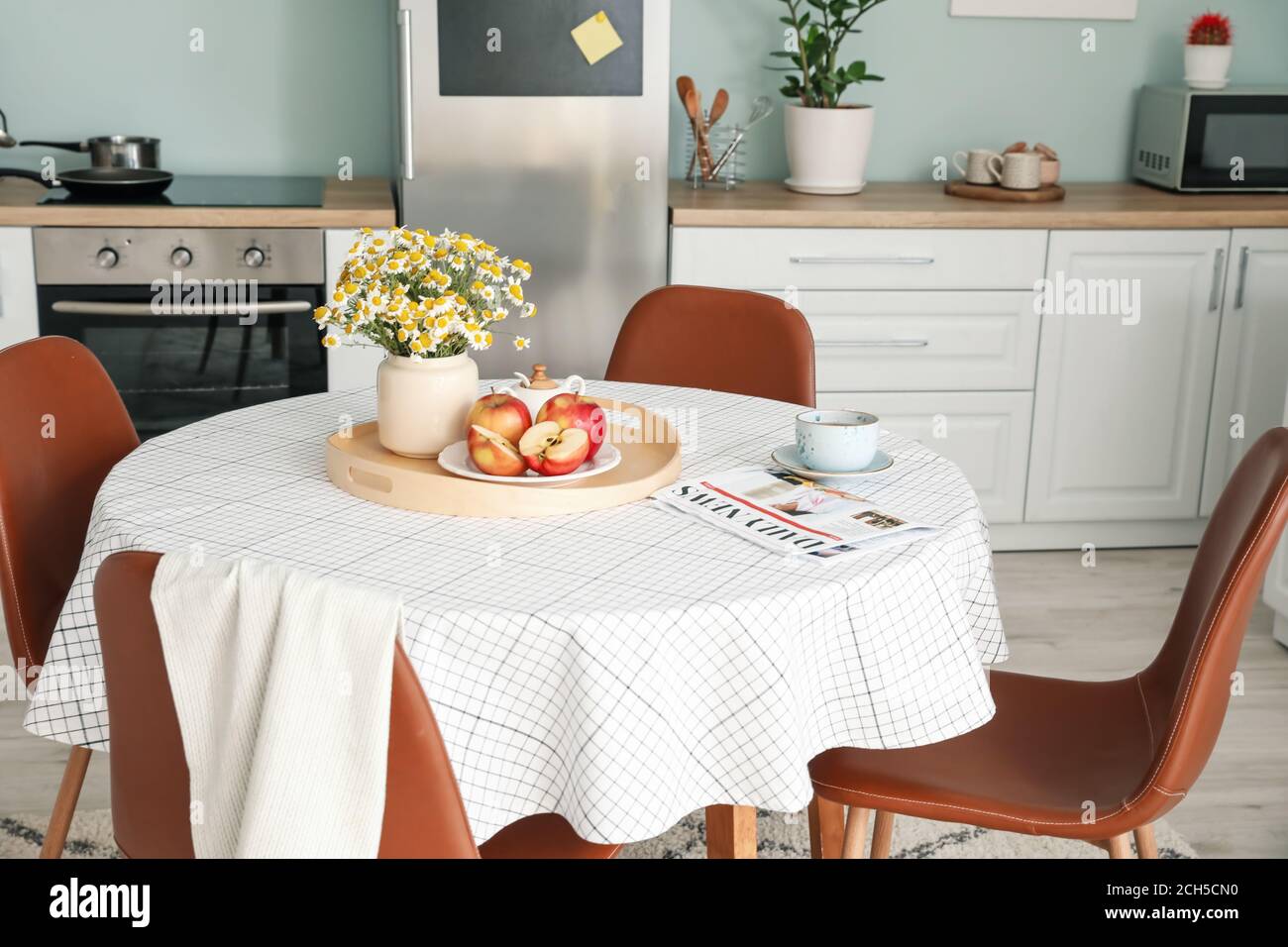 Dining table in interior of modern kitchen Stock Photo - Alamy