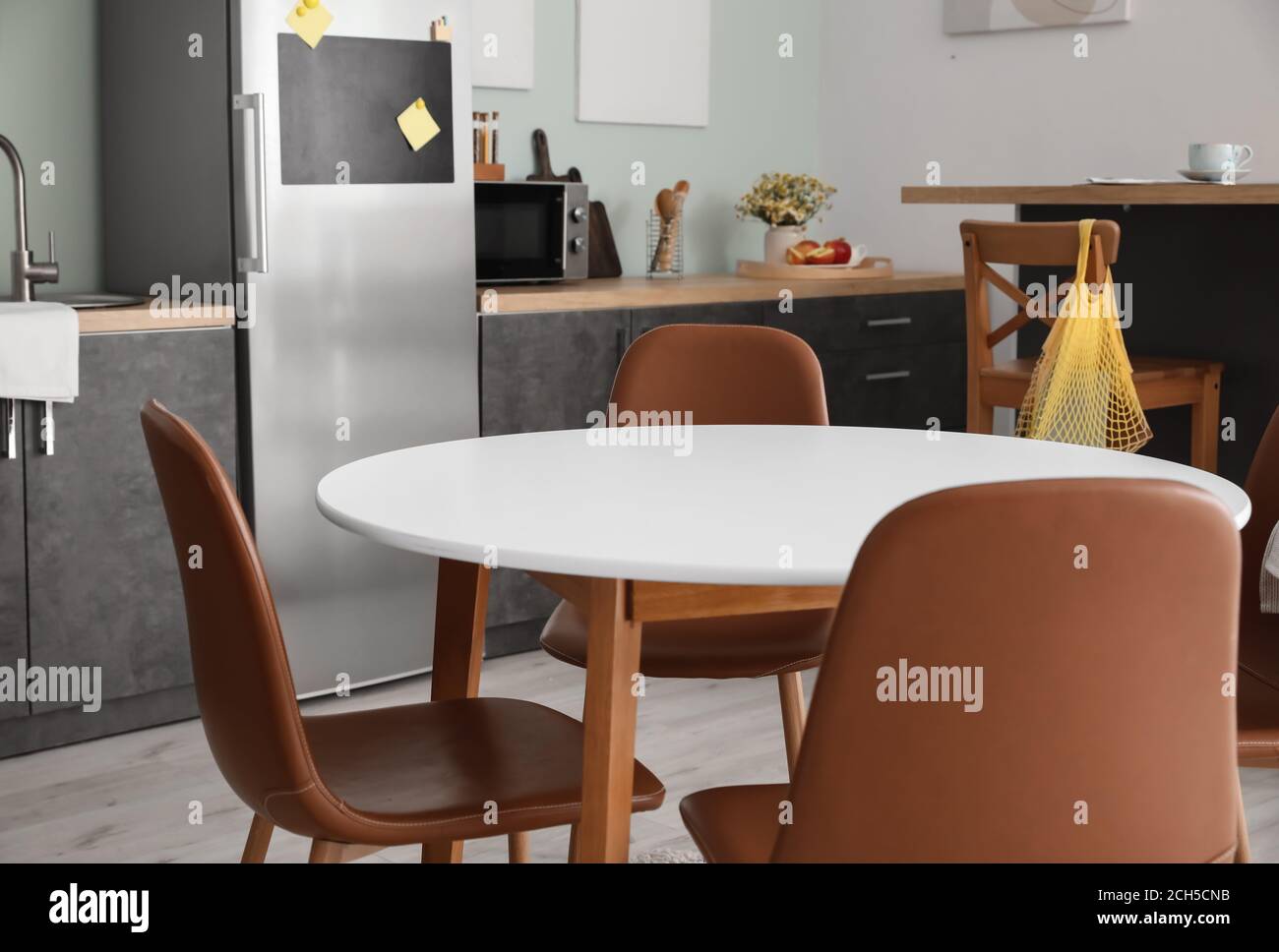 Dining table in interior of modern kitchen Stock Photo - Alamy