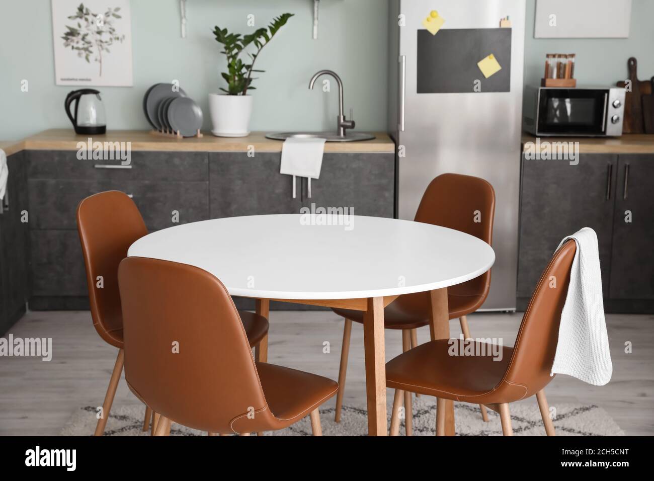 Dining table in interior of modern kitchen Stock Photo - Alamy