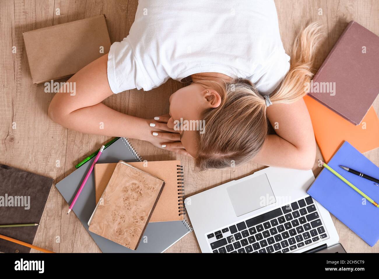 Tired student sleeping at table, top view Stock Photo - Alamy