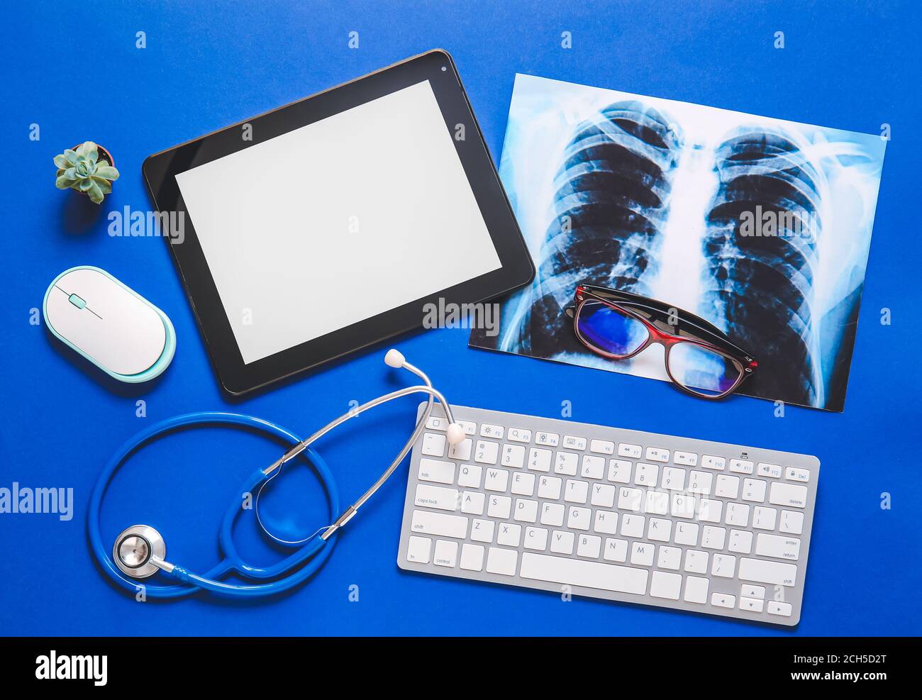 Composition with modern tablet computer, keyboard, x-ray image and ...