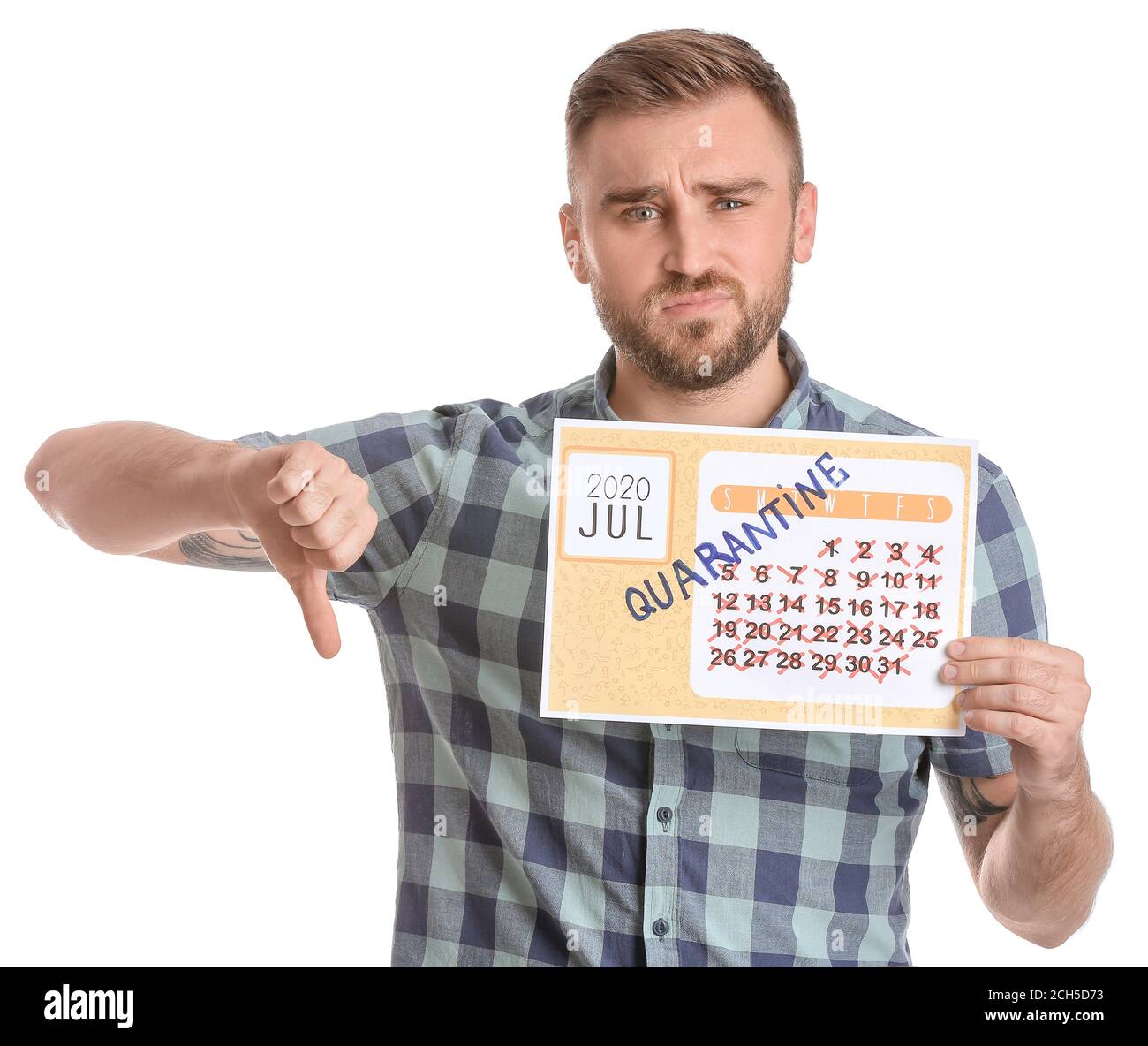 Displeased man holding calendar with written word QUARANTINE against ...
