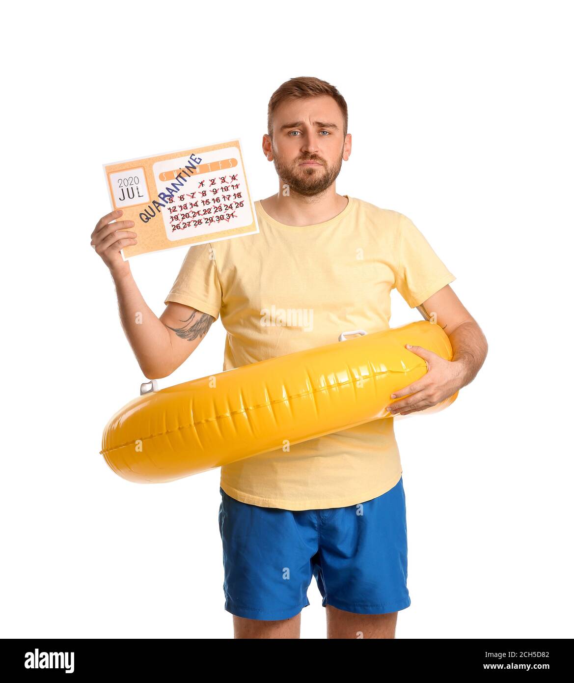 Sad man holding calendar with written word QUARANTINE and inflatable ...