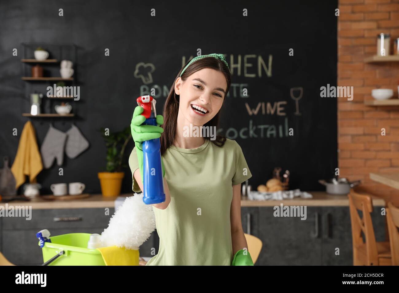 Beautiful young woman cleaning kitchen Stock Photo - Alamy