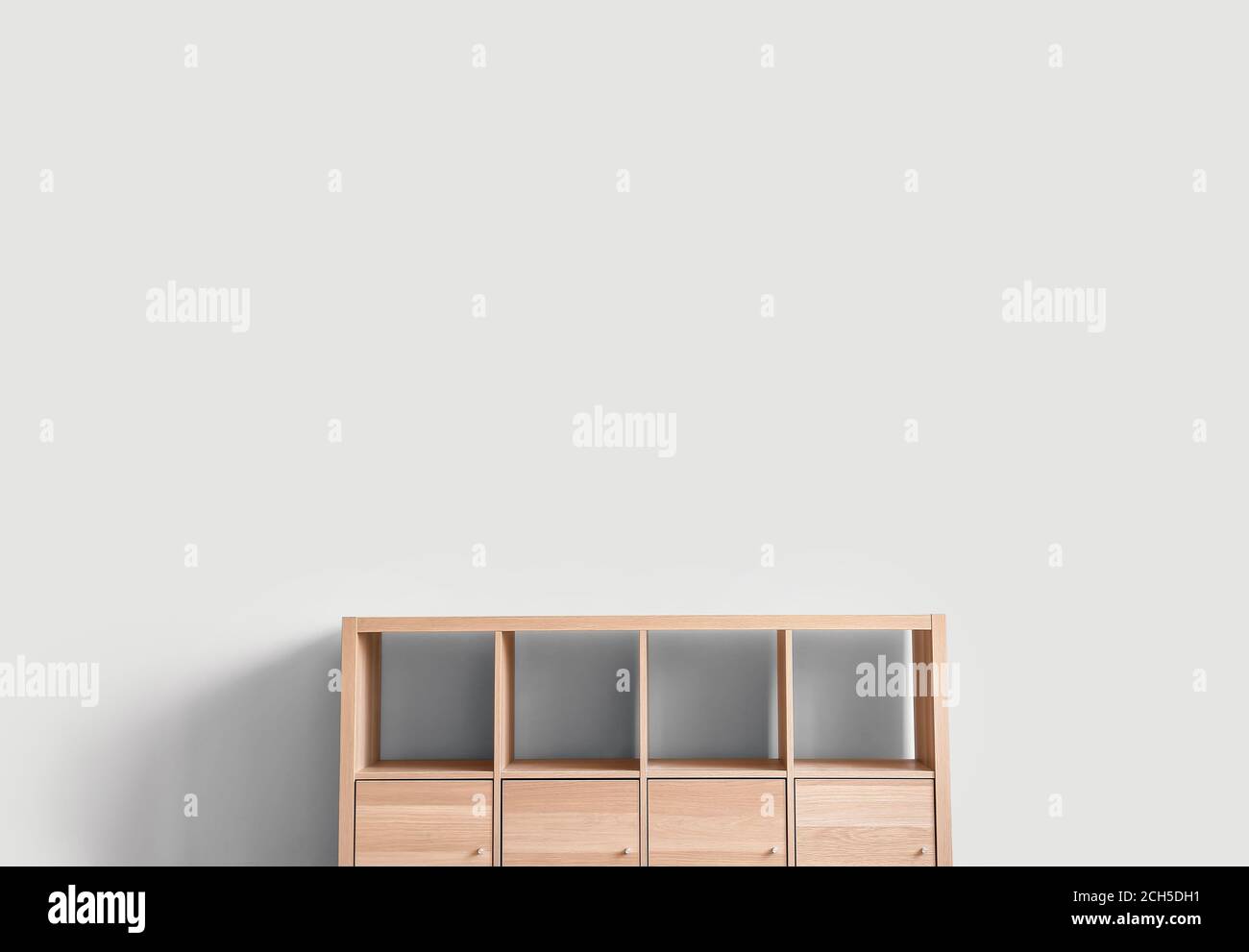 Wooden stand near light wall in room Stock Photo - Alamy