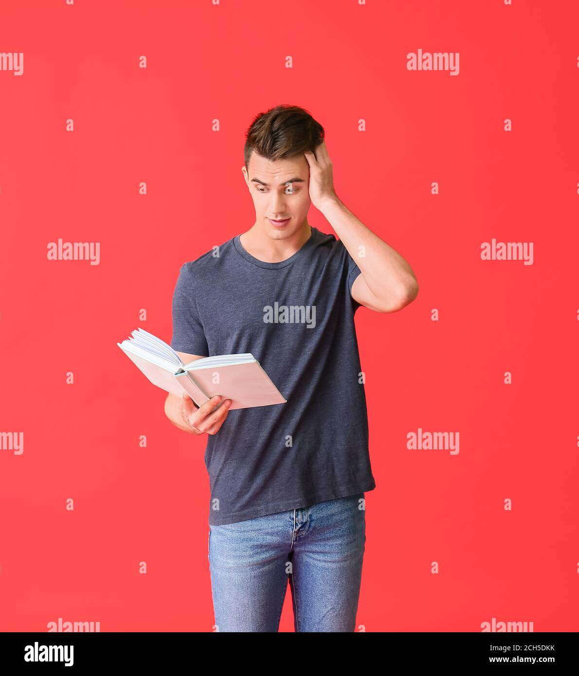 Young man confused book hi-res stock photography and images - Alamy