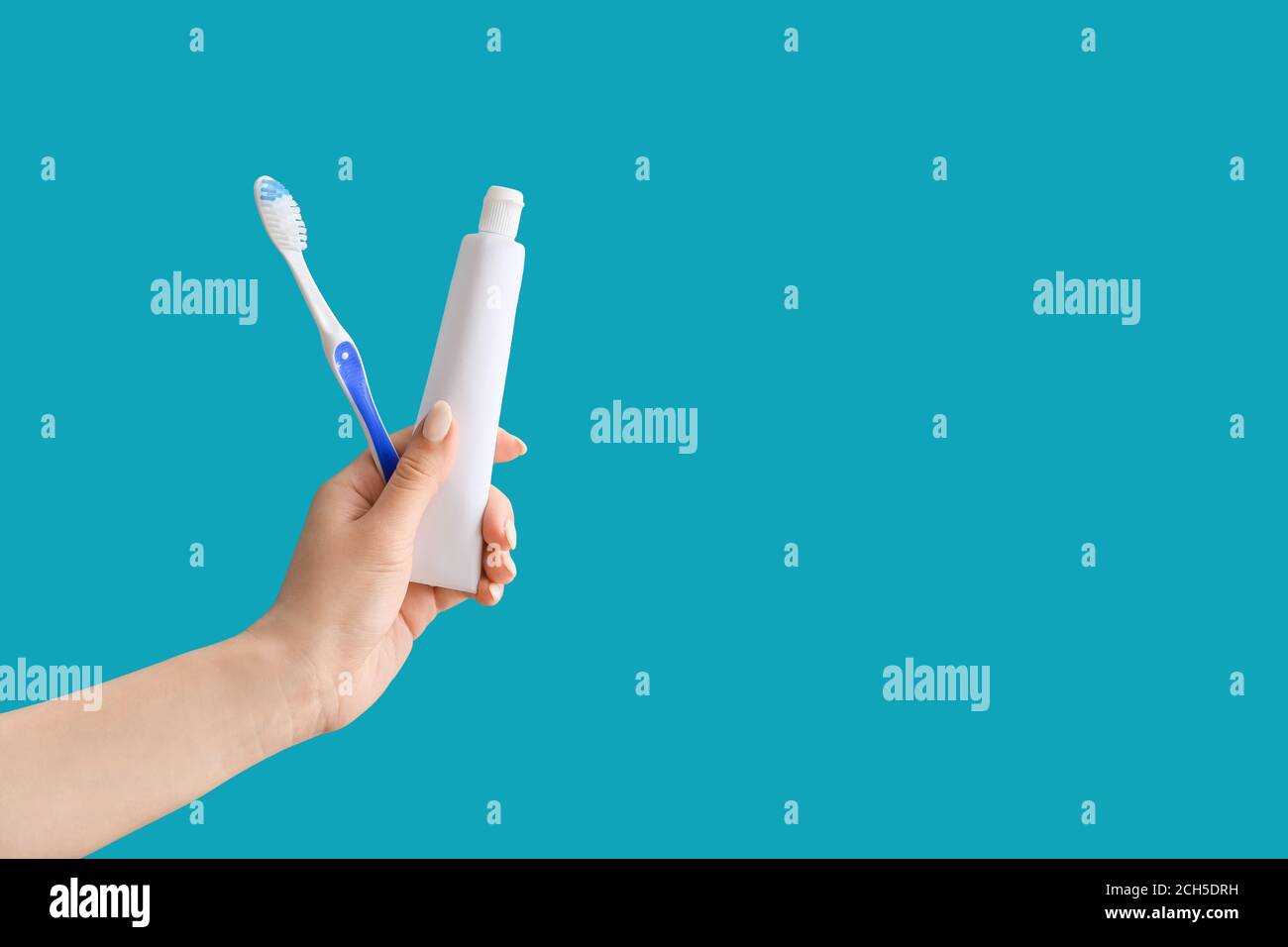 Hand with tooth brush and paste on color background Stock Photo - Alamy