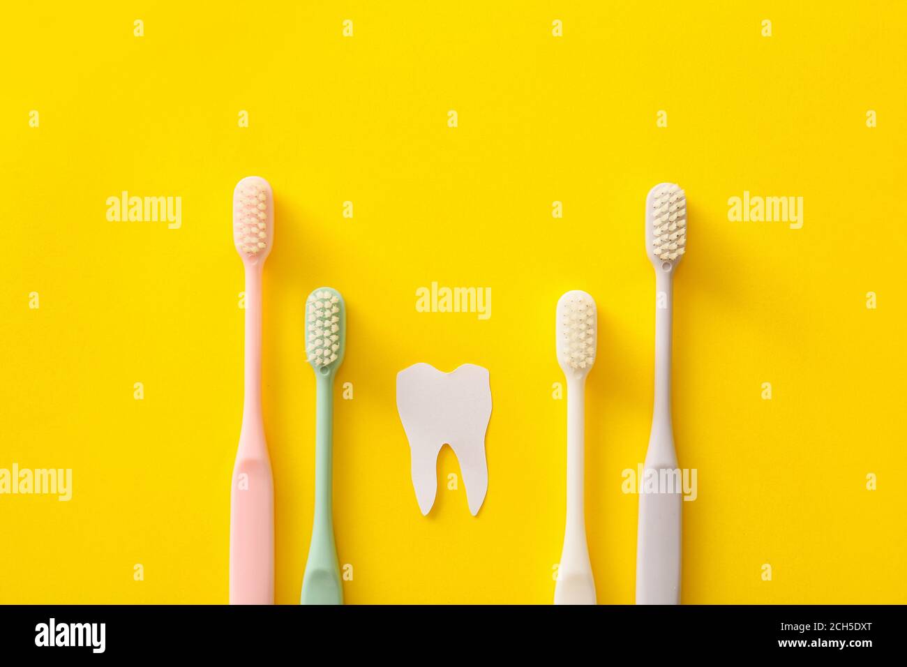 Tooth brushes on color background Stock Photo - Alamy