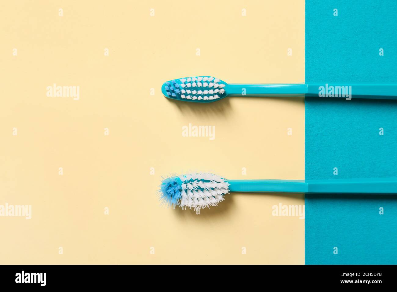 Tooth brushes on color background Stock Photo - Alamy
