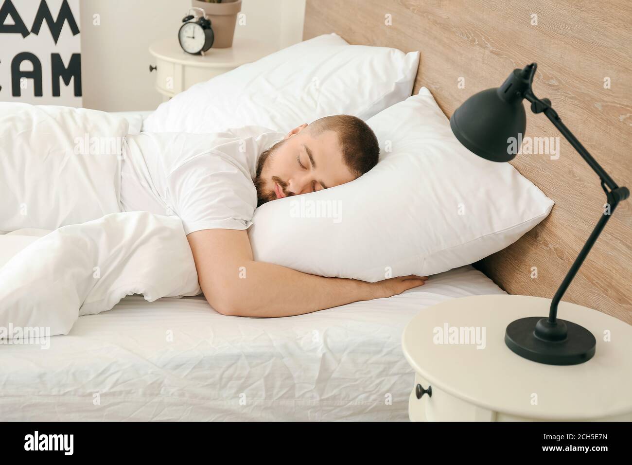 Young man sleeping in bed at home Stock Photo - Alamy