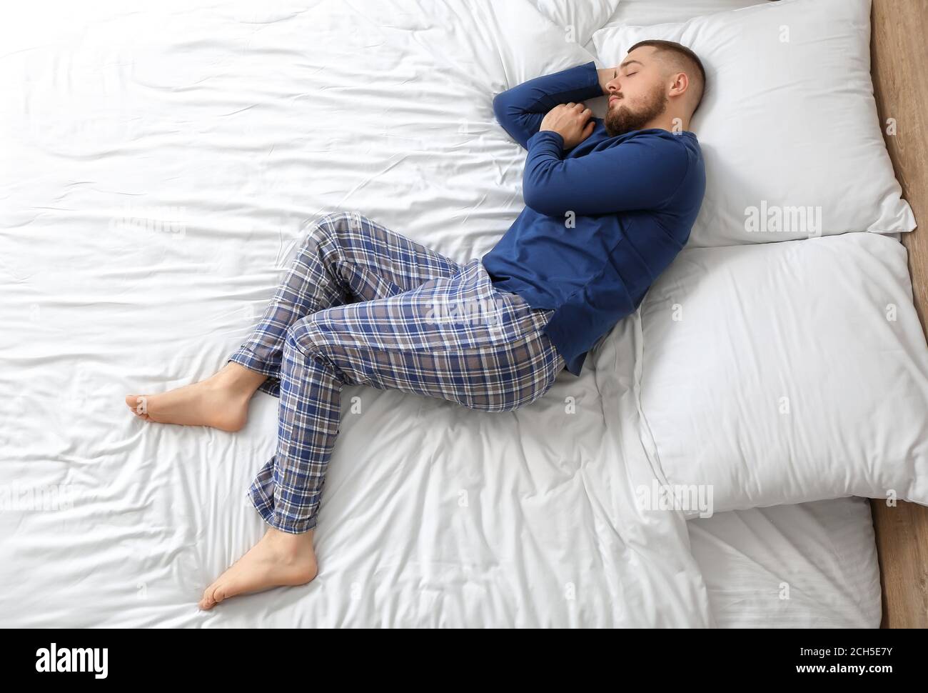 Young man sleeping in bed at home Stock Photo - Alamy
