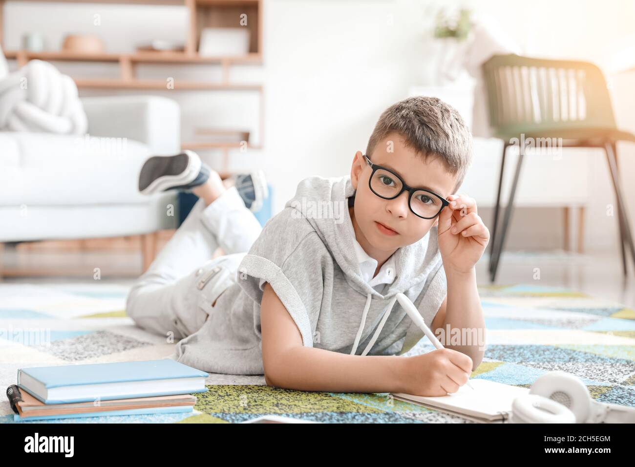 Cute little boy studying at home Stock Photo - Alamy
