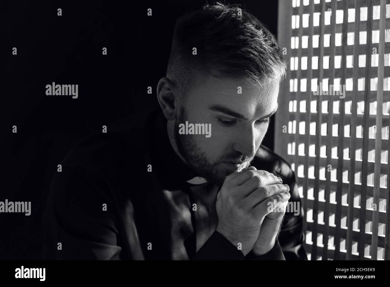 Catholic priest confession black white hi-res stock photography and ...