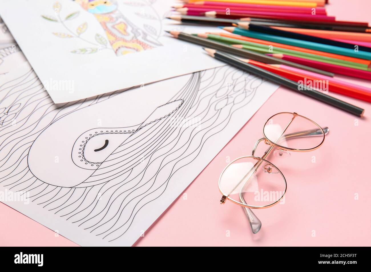 Coloring pictures, markers and pencils on table Stock Photo - Alamy
