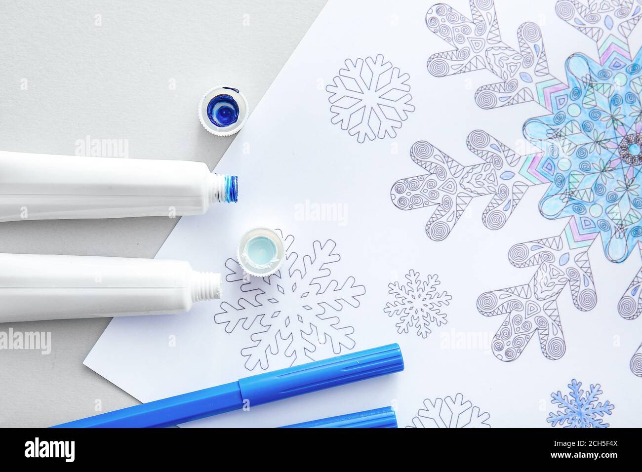 Coloring picture, markers and paints on table Stock Photo - Alamy