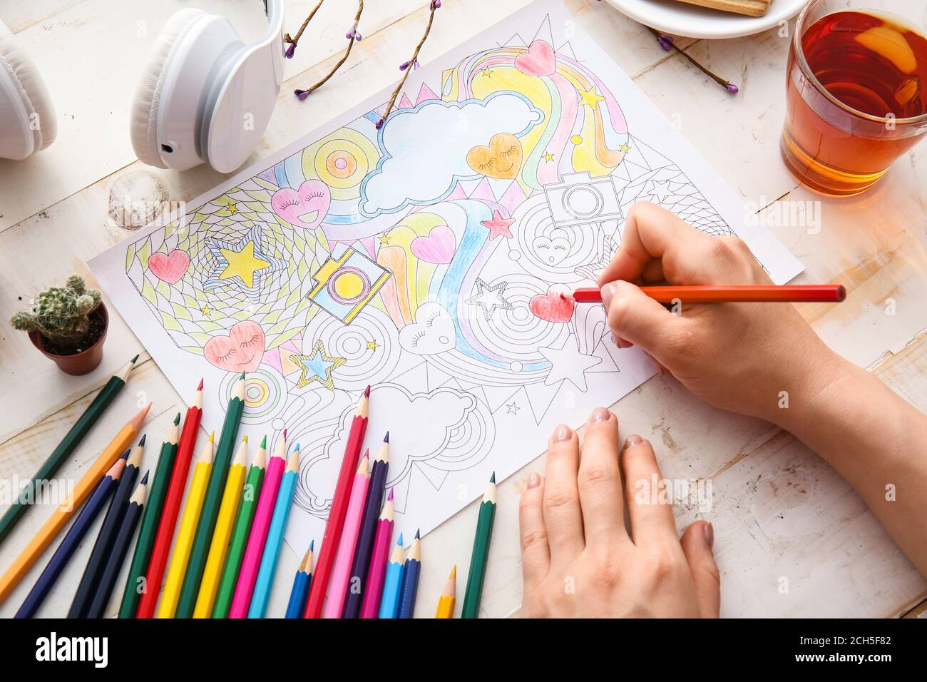 Woman coloring picture at table Stock Photo - Alamy