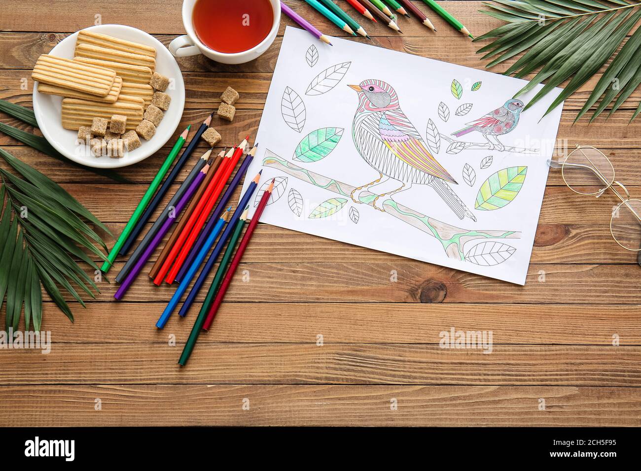 Composition with coloring picture on table Stock Photo - Alamy