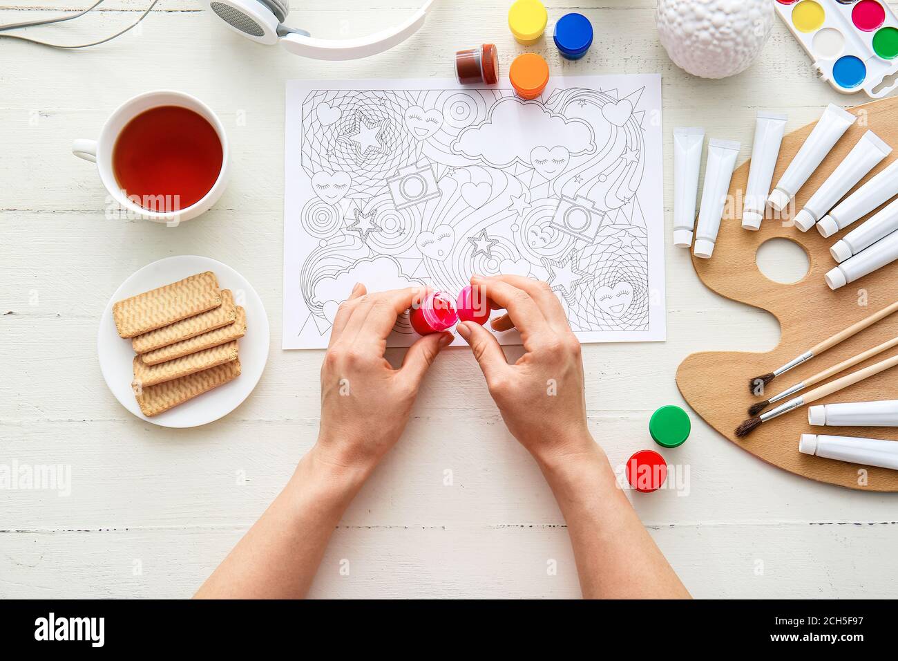 Woman coloring picture at table Stock Photo - Alamy