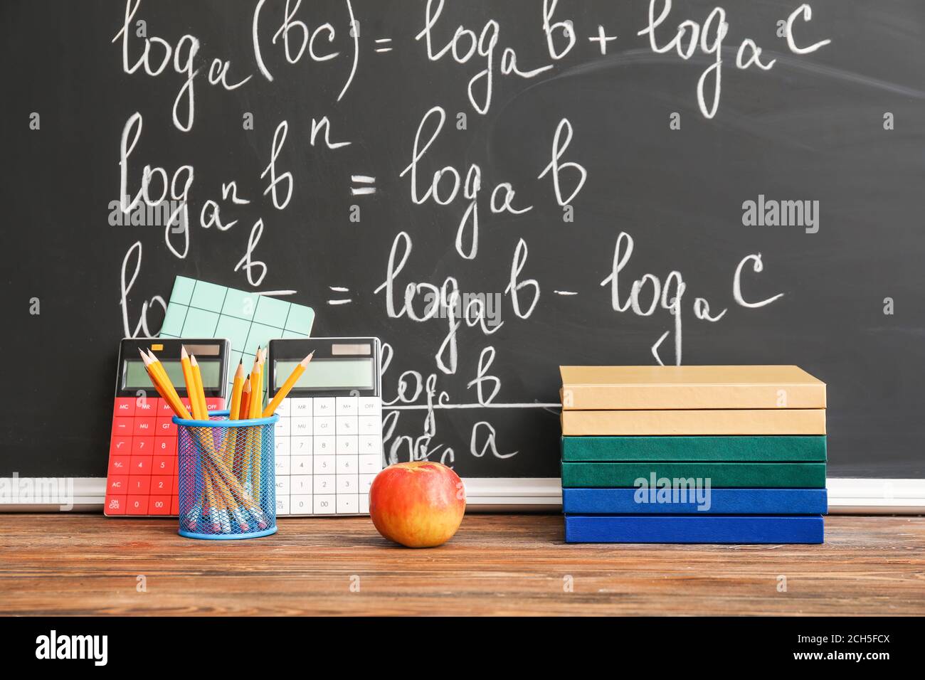 Stationery on desk in classroom Stock Photo - Alamy