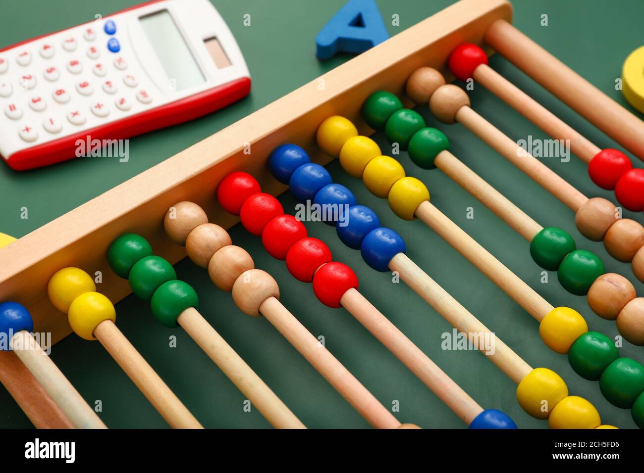 Abacus and calculator on color background Stock Photo - Alamy