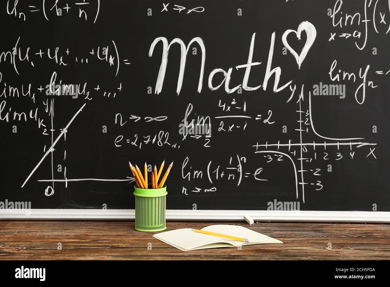 Stationery on desk in classroom Stock Photo - Alamy