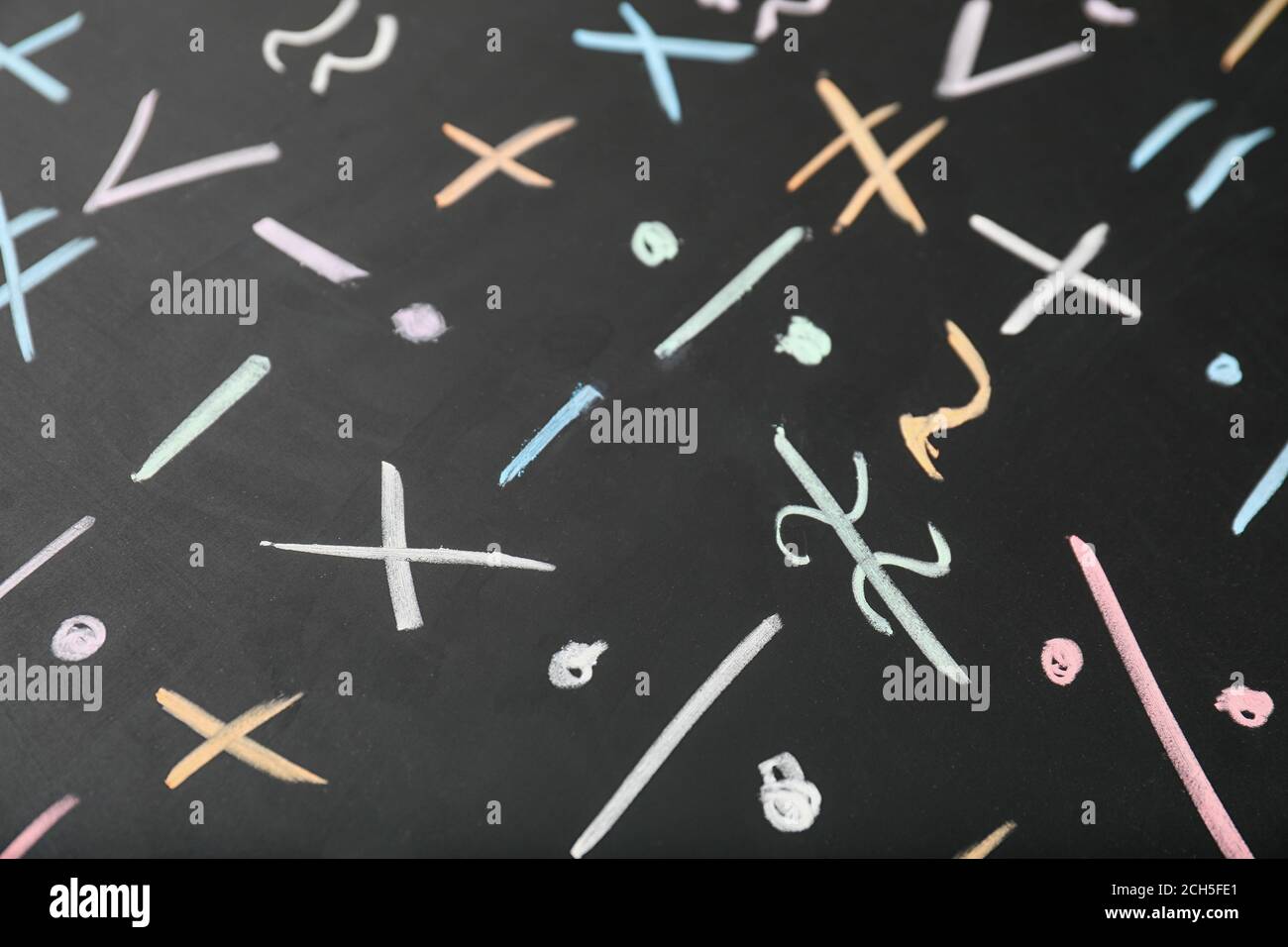 Mathematical symbols written on blackboard Stock Photo - Alamy