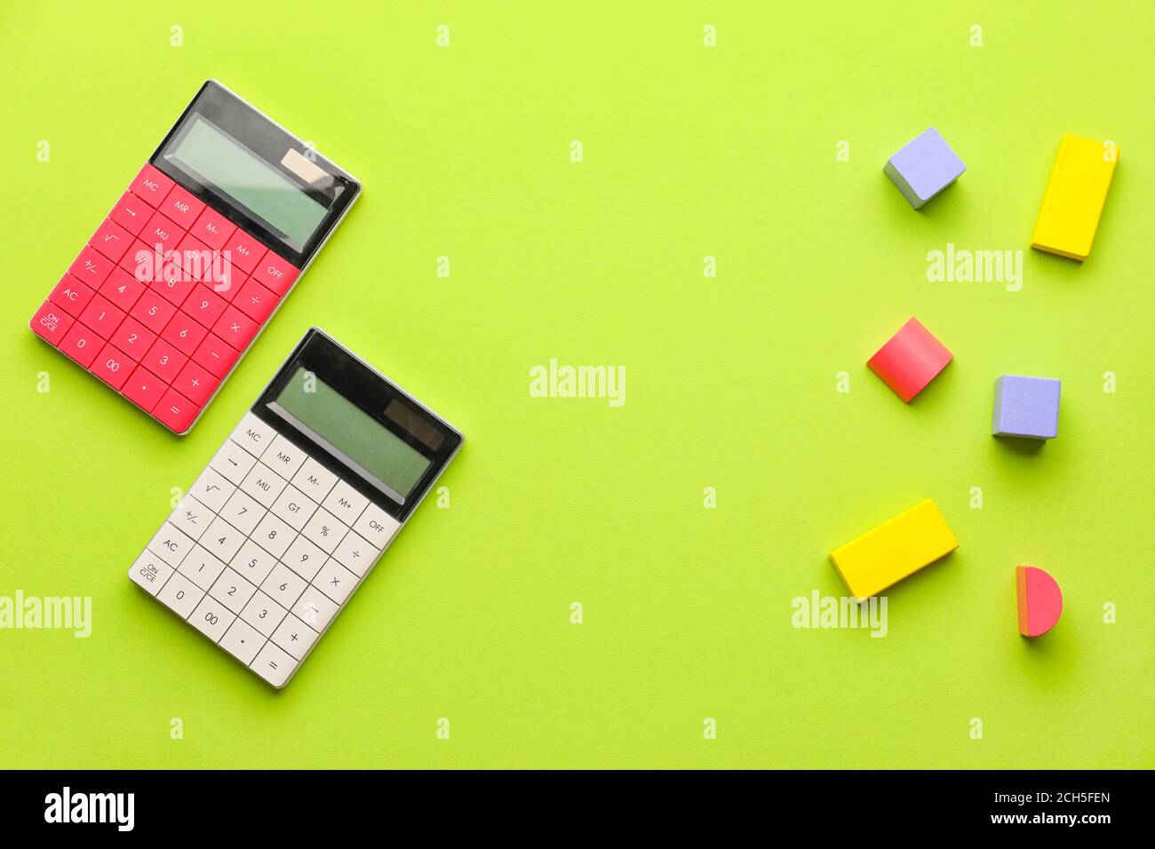 Calculators and wooden blocks on color background Stock Photo - Alamy