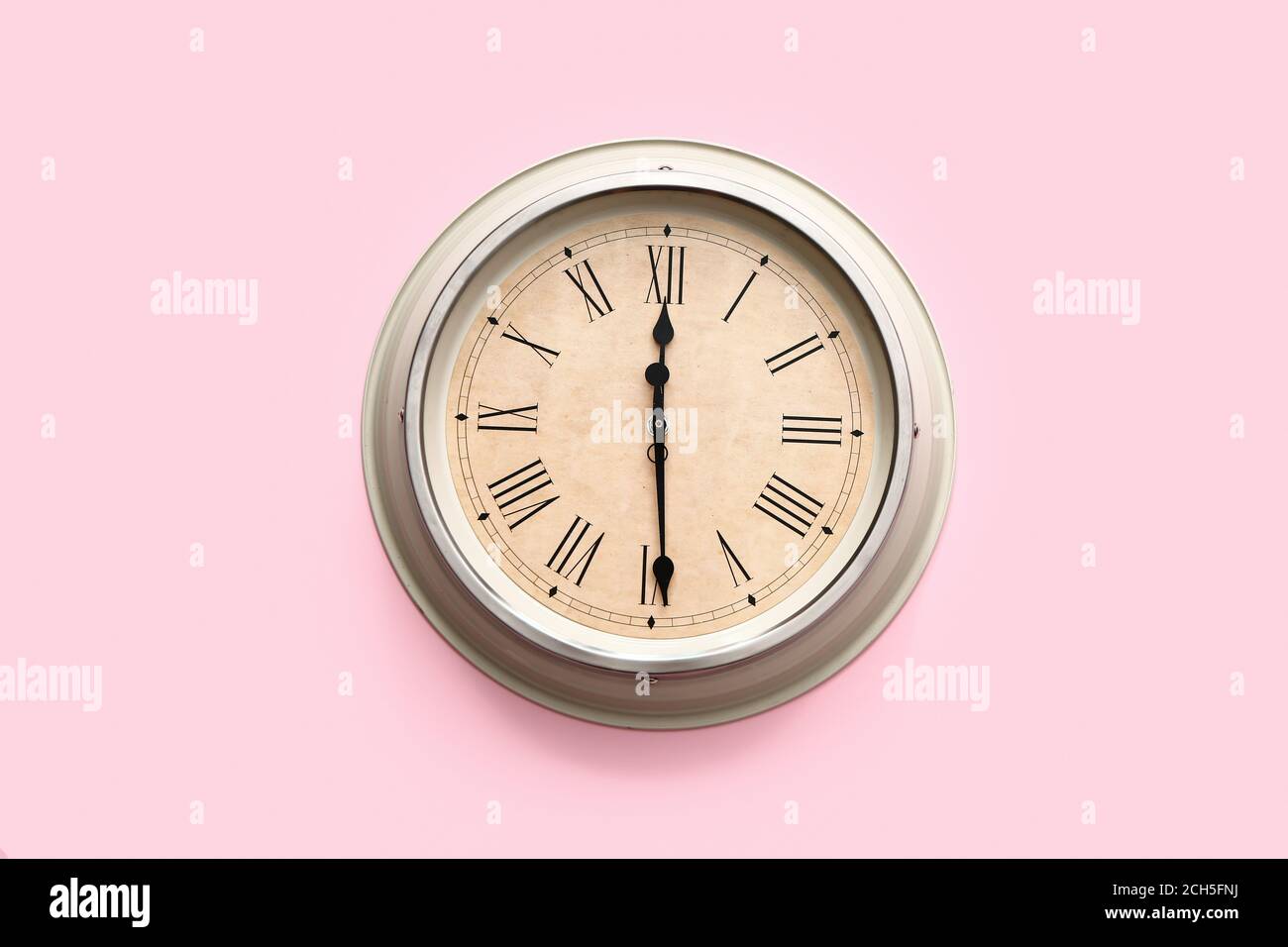Simple clock on color background Stock Photo - Alamy